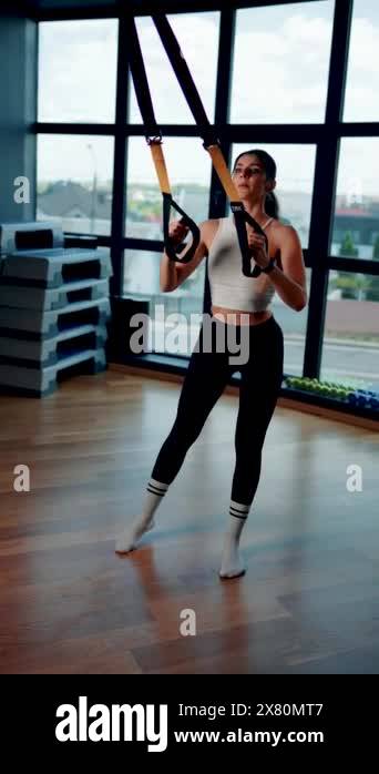 Beautiful woman doing exercise with trx system.Fitness exercises with loops.Concept workout ...