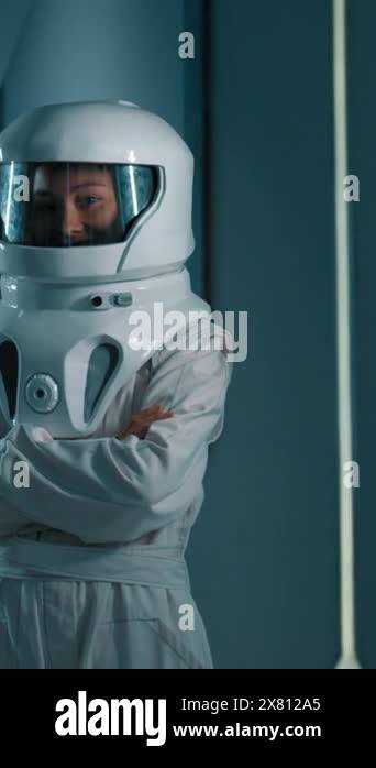 A woman in an astronaut costume looks confidently at the camera. The ...