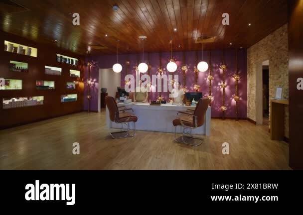 Asian spa staff greeting in reception hall. Hotel lobby receptionists ...