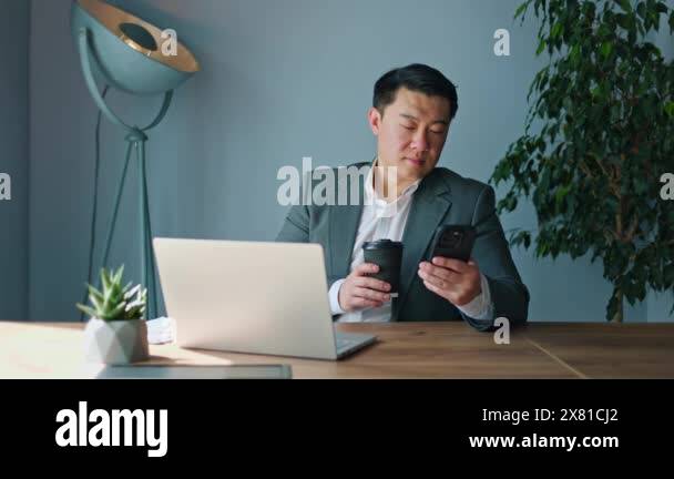 Relaxed handsome male making sip of hot beverage while lounging at ...