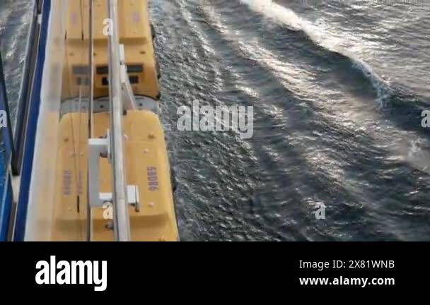 Lifeboat on giant cruise ship view down to ocean surface with waves ...