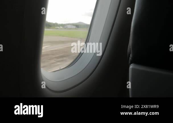 selective focusing view to plane window of airplane while take off from ...