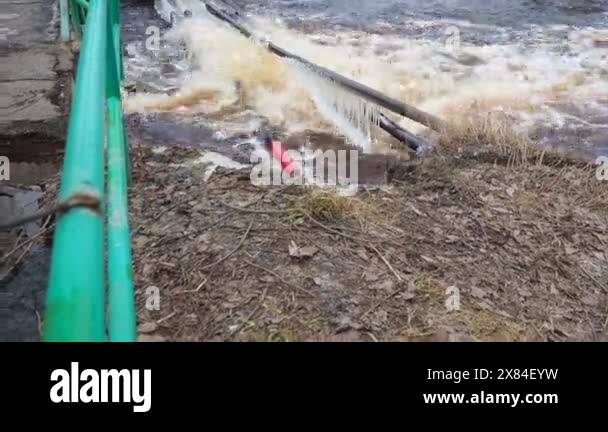 Spring flood. Rushing water in the river. Dark ferrous water rushes in ...