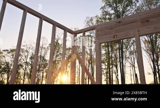 An unfinished interior of newly built house with wooden framing ...