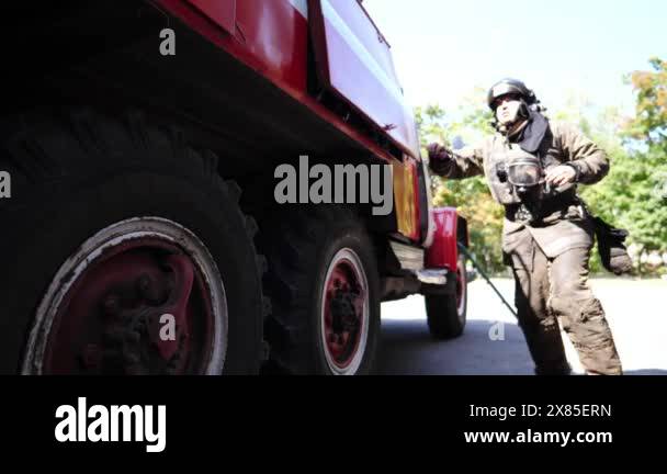 Male firefighter opening door of cabin and fast exiting from passenger ...