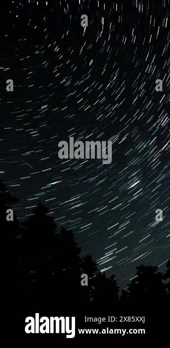 Time lapse of Star trails in the night sky. Stars move around a polar ...