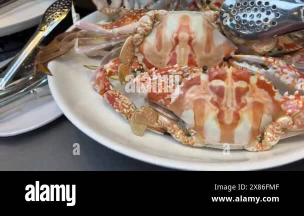 Hand of chef in restaurant during cut and removing shell of big size ...