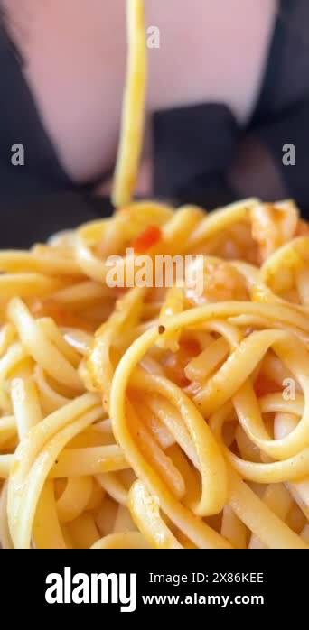young teenage girl with wet hair eats spaghetti pasta pull spaghetti ...