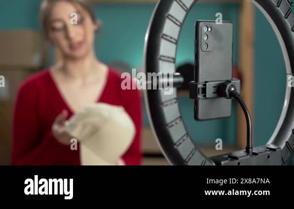 A content creator is filming a craft tutorial using a smartphone on a ...