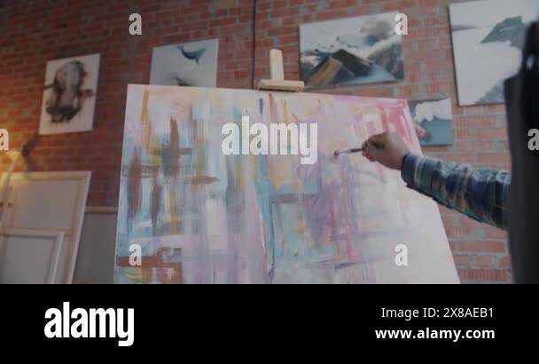 Zoom-out of talented artist Indian man painting abstract picture ...