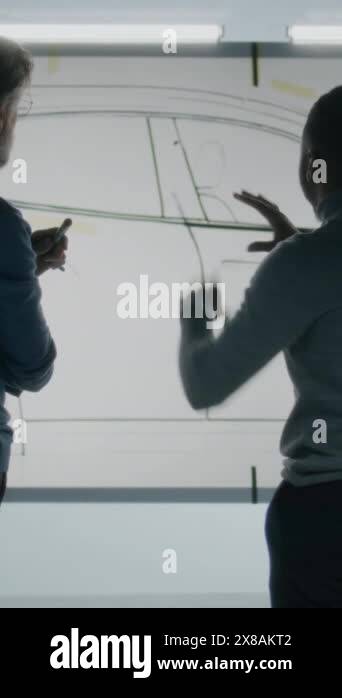 Two diverse automotive male designers standing near sketch on ...