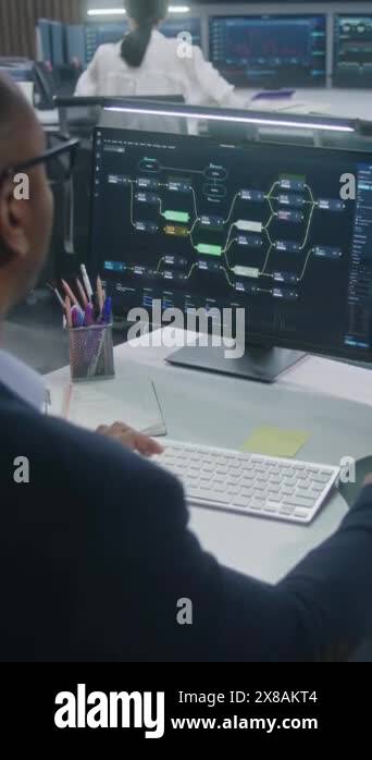African American big data scientist works at computer with displayed ...