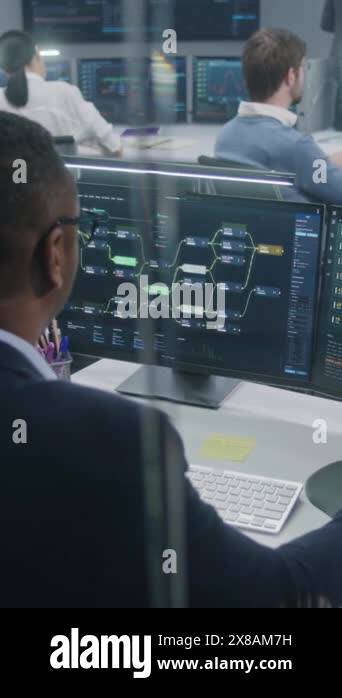 African American big data scientist works at computer in monitoring ...