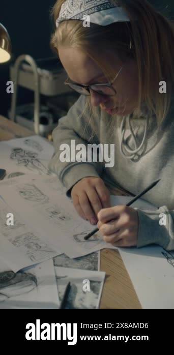 Female animator creates sketches for the cartoon. Looks at the laptop ...