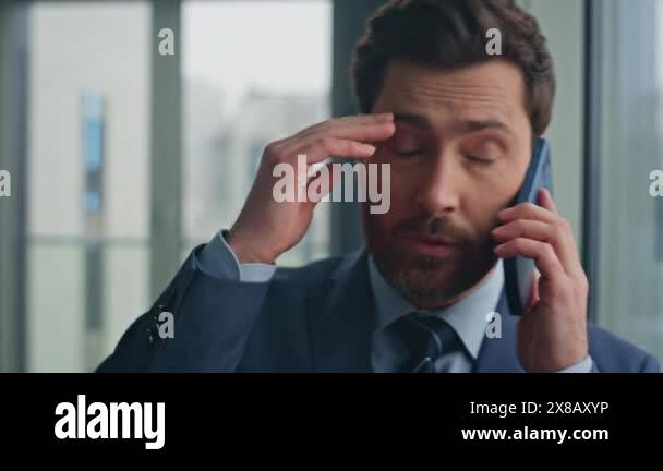 Desperate manager ending call standing office window closeup. Sad ...