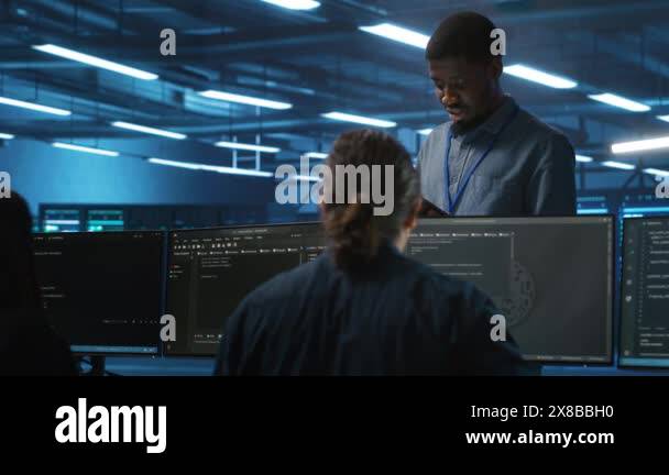 Supervisor in server hub workplace managing diverse team of developers ...