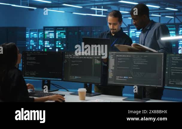 Man inspecting server farm, reading paperwork, following inspection checklist, talking with ...