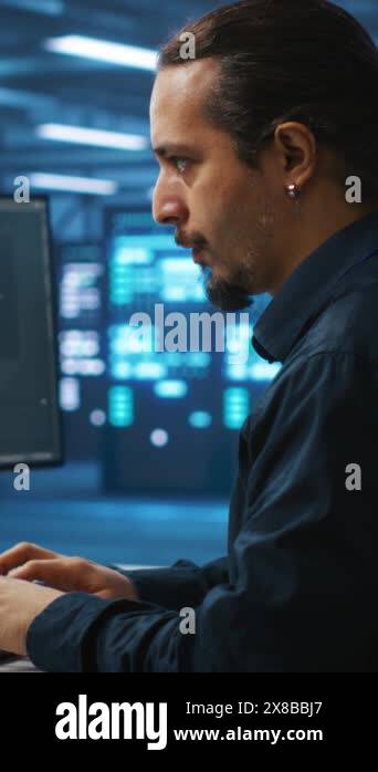 Vertical video System administrator working in high tech server room capable of storing vast ...