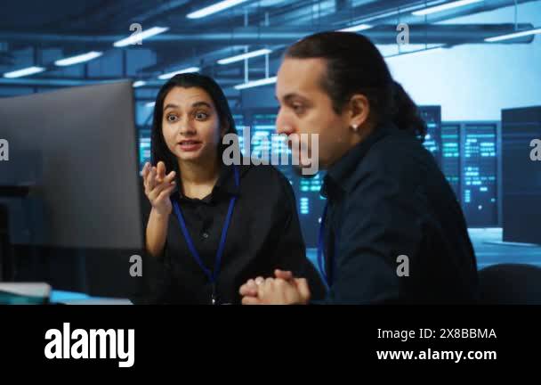 Programmers Talking In High Tech Server Hub Using Pcs To Analyze Data