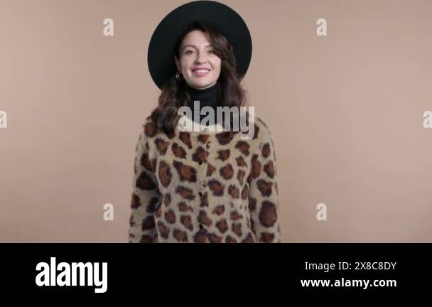 Gorgeous woman in leopard outfit showing yes signal, nods head, approve ...