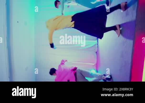 Abstract view of people dancing in a club with vibrant neon lights and ...