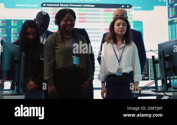 Diverse group of business professionals posing together in monitoring ...