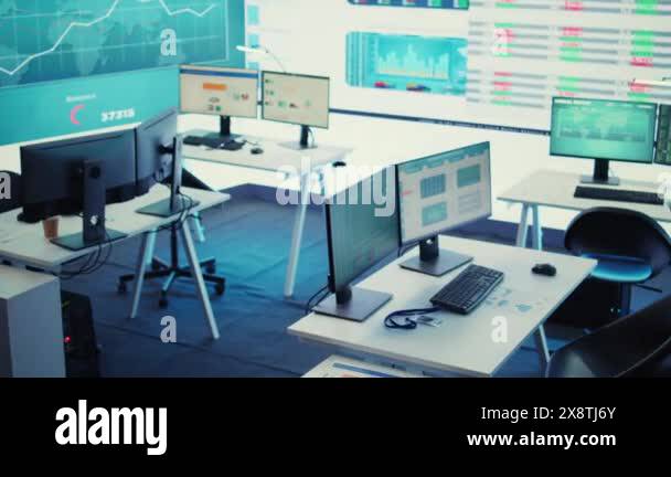 Empty telecommunications control room with workstations, coworking ...