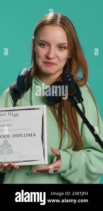 Vertical video Happy student holding diploma talking in microphone ...