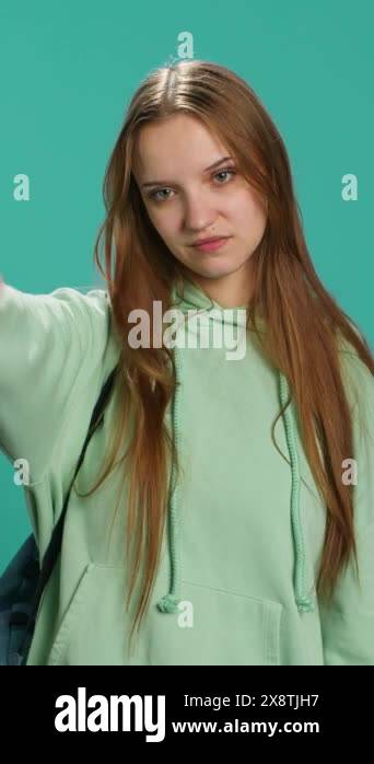 Vertical video Frustrated woman showing thumbs down sign gesturing ...