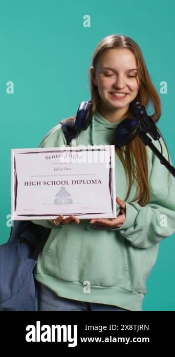 Vertical video Happy student holding diploma talking in microphone ...