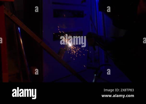 The process of a welder working on a metal product. Welder using ...