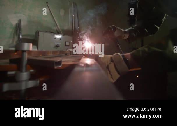 Welding machine working process on metal product. Metalworker using ...
