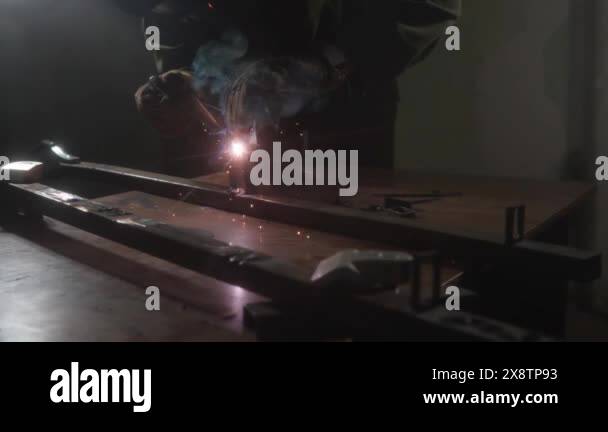 Welding machine working process on metal product. Metalworker using ...