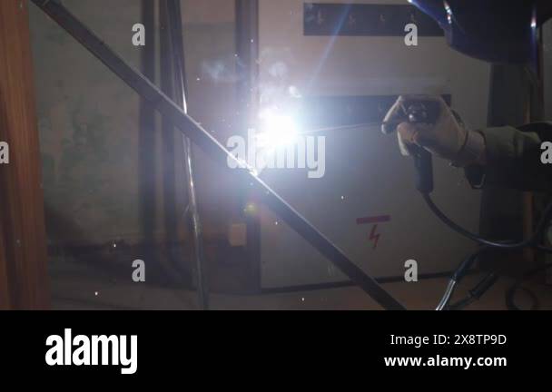 Welding machine working process on metal product. Metalworker using ...