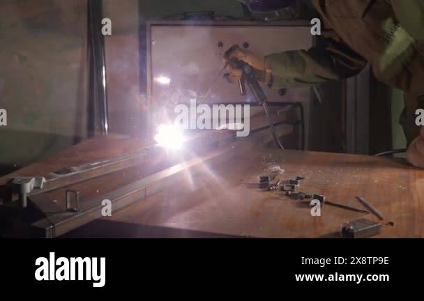 Welding machine working process on metal product. Metalworker using ...