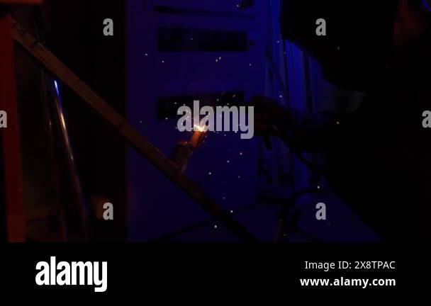 The process of a welder working on a metal product. Welder using ...