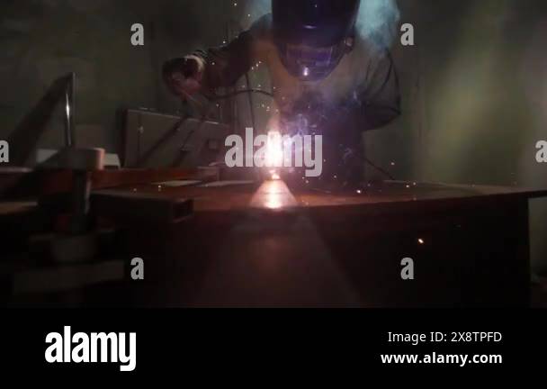 Welding machine working process on metal product. Metalworker using ...