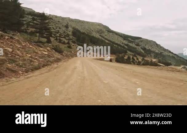 Scenic drive captures dirt road amidst natural surroundings. Video ...