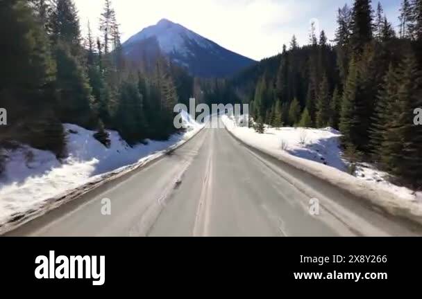 Scenic Highway surrounded by Mountains, Trees and Snow. Daytime, Duffy ...