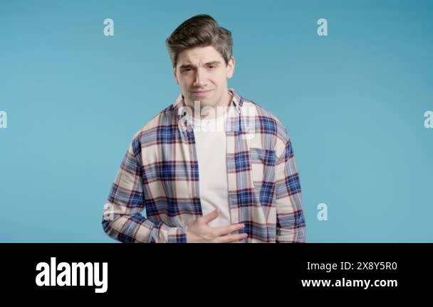 Man squeezing belly with hands because of abdominal pain. Adult guy ...