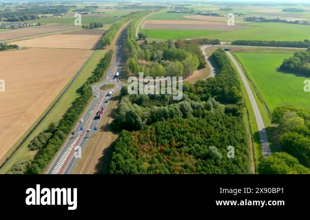 Aerial view of vehicles taking a two-lane roundabout and secondary ...