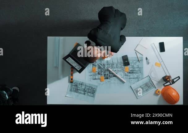 Top view of skilled project manager holding project plan and explain ...