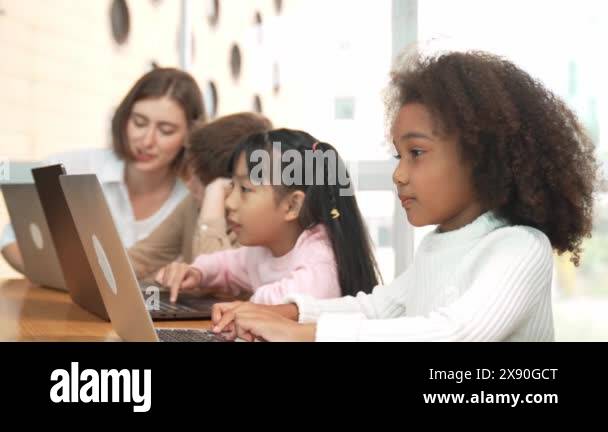 African girl play laptop with diverse friend learning prompt at STEM technology class ...