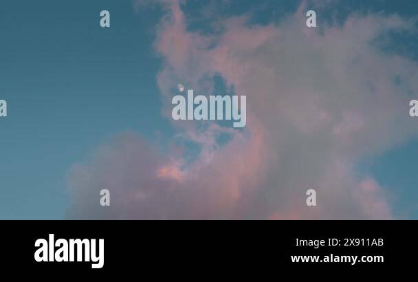 Waning gibbous moon on blue sunset sky with pink clouds Stock Video ...