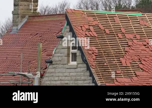 Roof tiles blown off a house roof following Storm Arwen. Filmed in ...