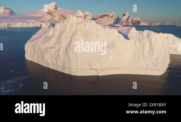 Rise up panorama over sunset iceberg floating in Antarctica. Giant ice ...