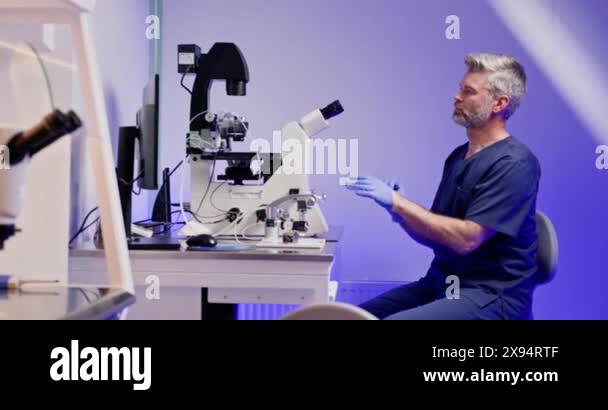 Embryologist performing artificial fertilization of an egg in a ...