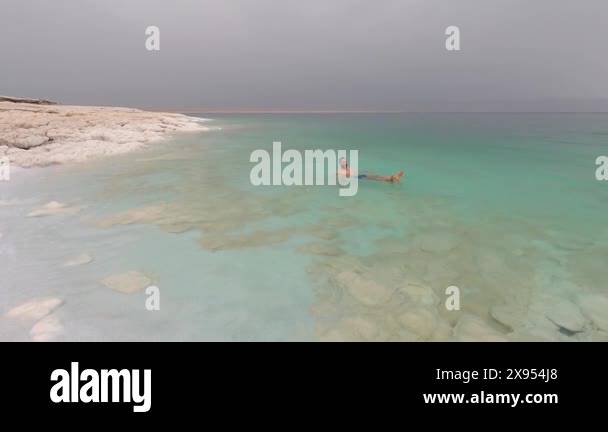 Video of relaxing tourist man while taking a bath in the floating Death ...