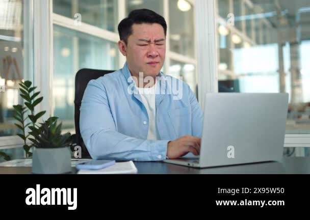 Worried male working by pc indoor while feeling sharp dental pain and ...