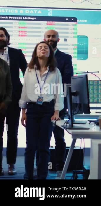 Vertical Video Diverse group of business professionals posing together in monitoring room ...